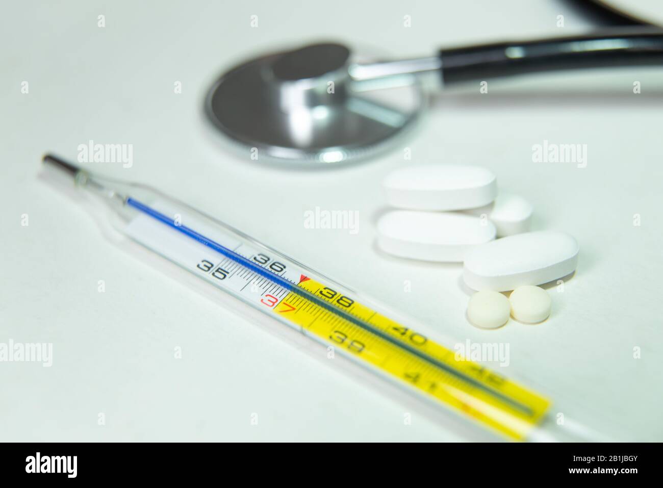 Thermometer and tablets for healthcare Stock Photo - Alamy