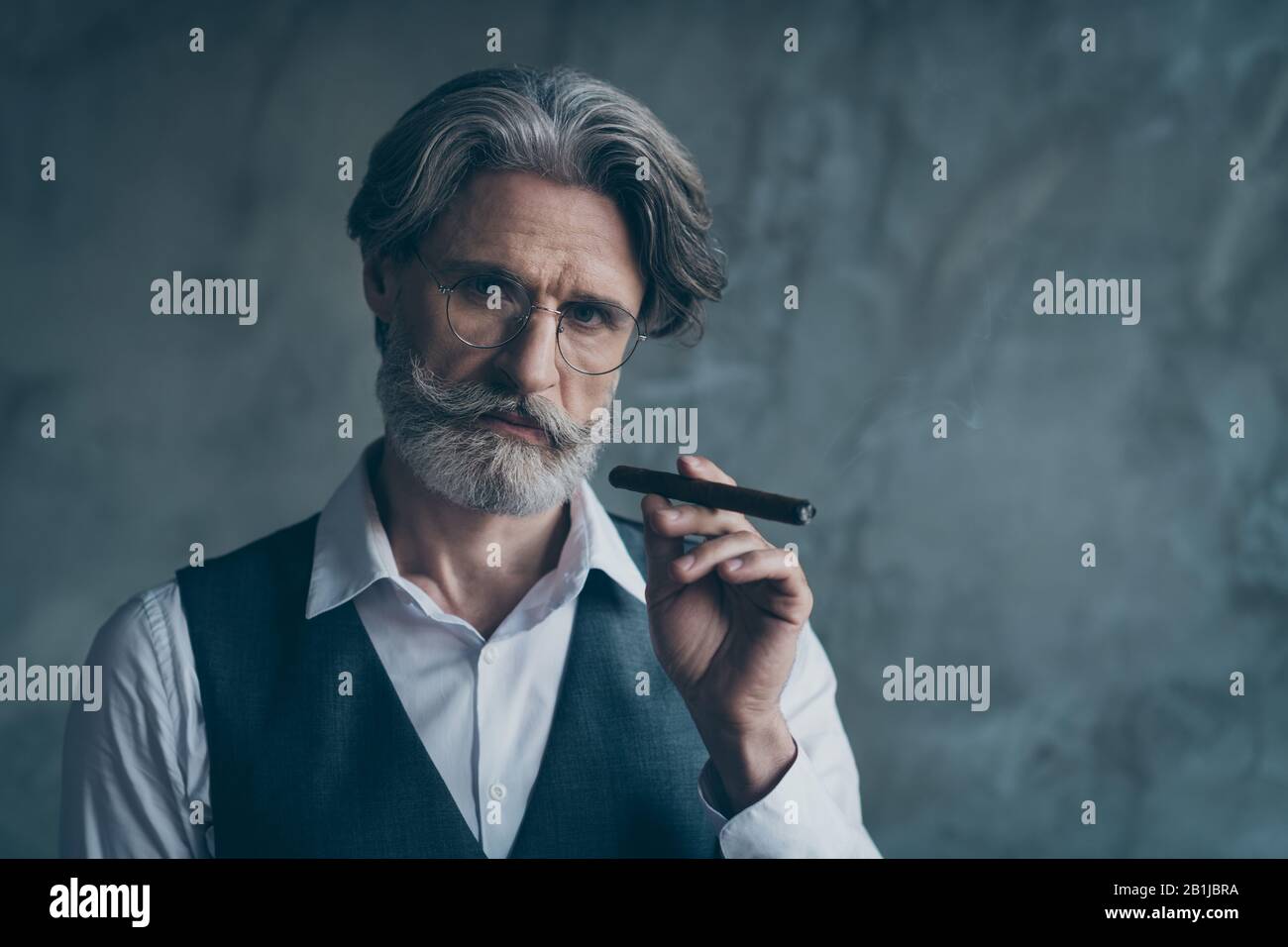 Portrait of harsh masculine brutal stunning old man hold cigar enjoy ...