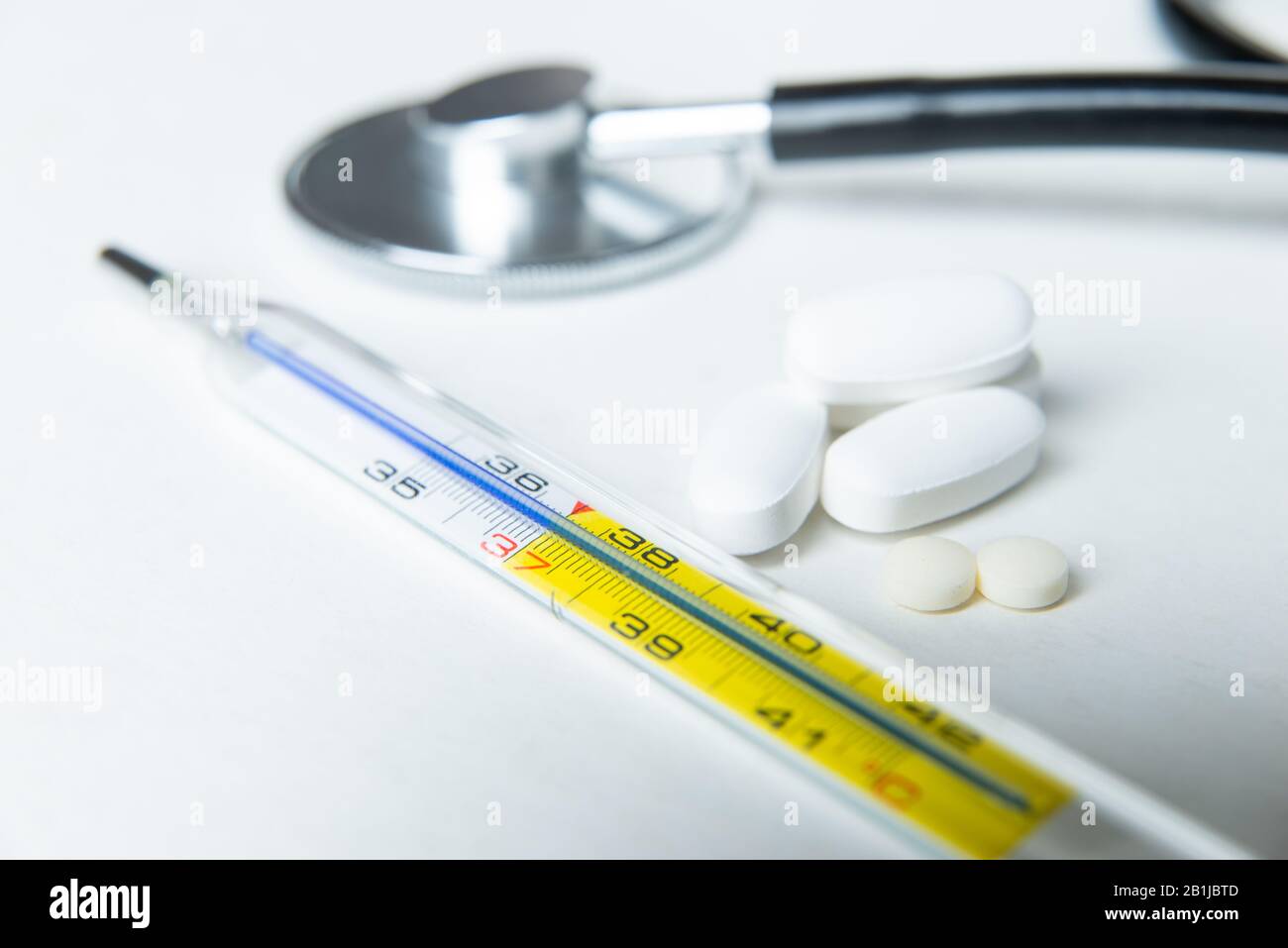 Thermometer and tablets for healthcare Stock Photo - Alamy