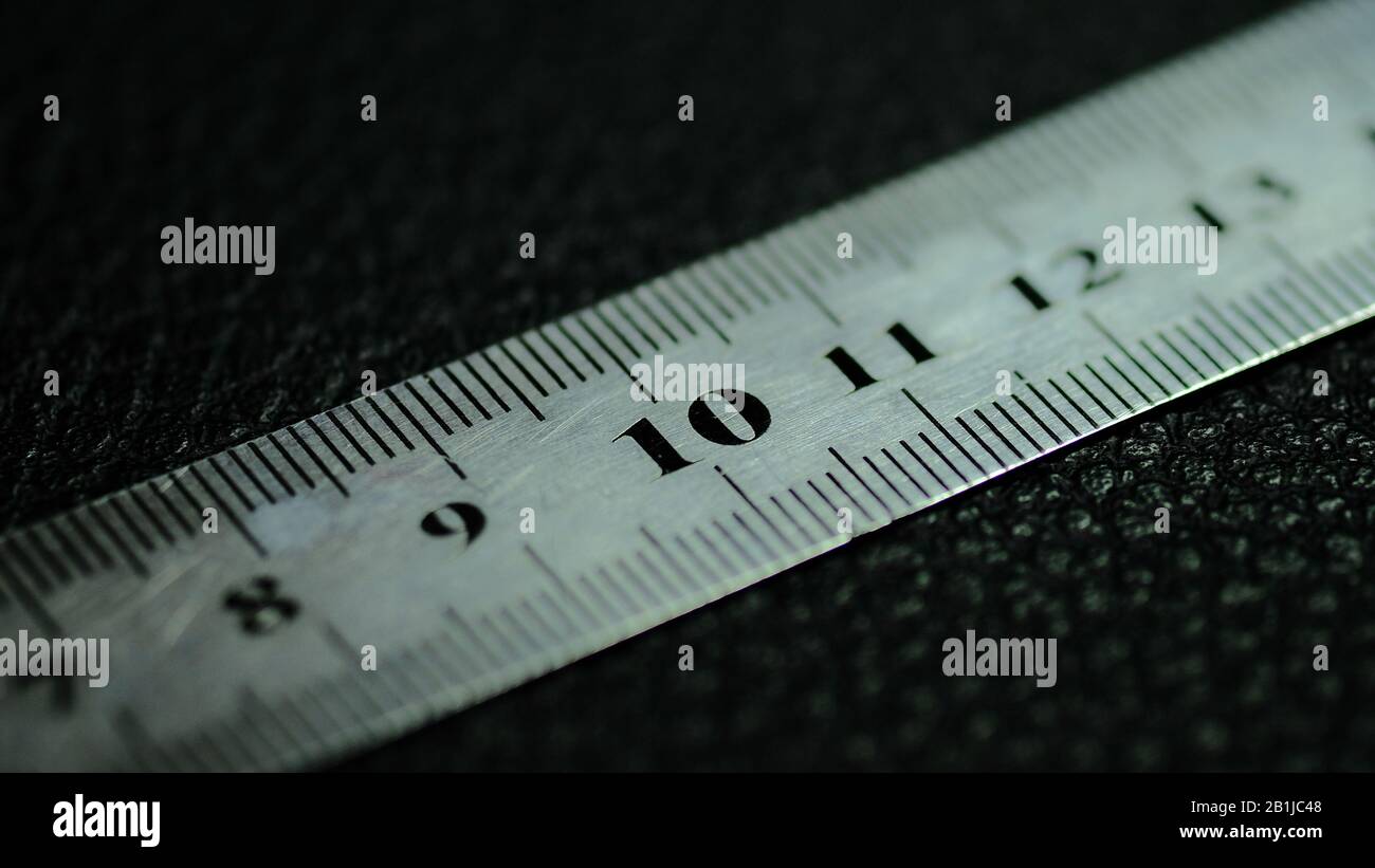 Metal ruler on a black background with a clear number 10 Stock Photo ...