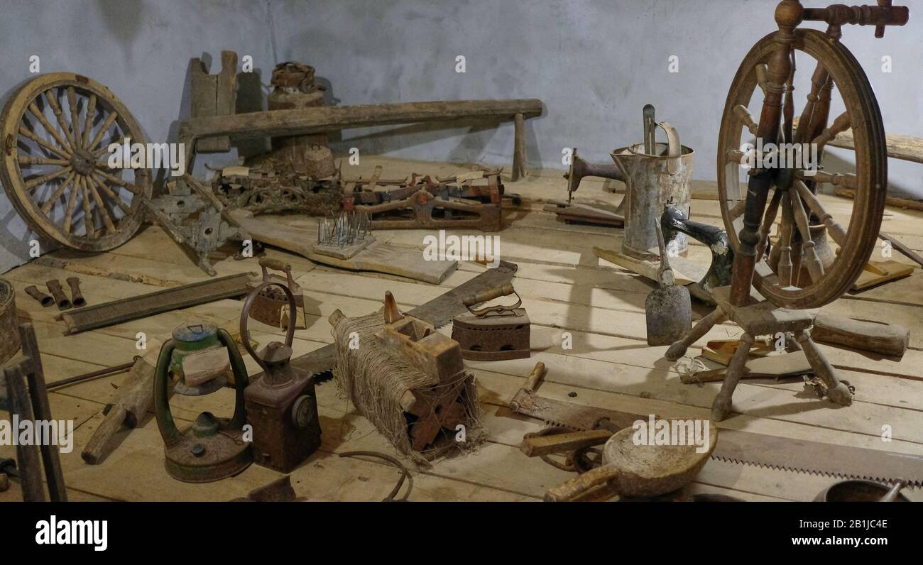 Lots of antique handicraft household items indoors and on the floor ...