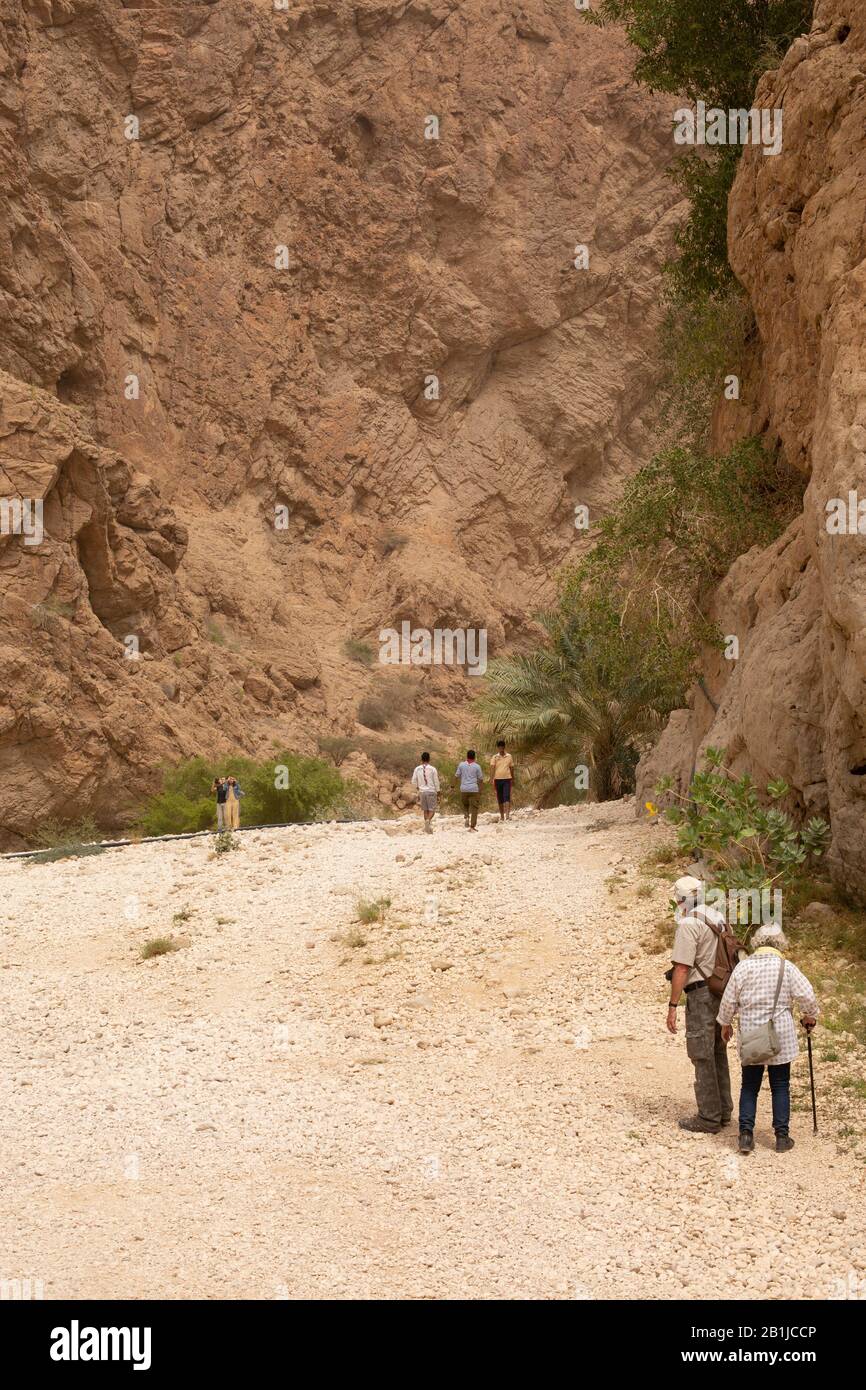 People walking on a path at Wadi Shab in Oman Stock Photo - Alamy