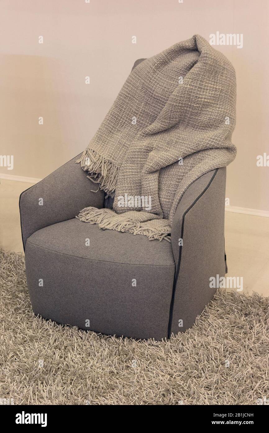 Comfortable modern chair and a cozy blanket. Interior Stock Photo - Alamy