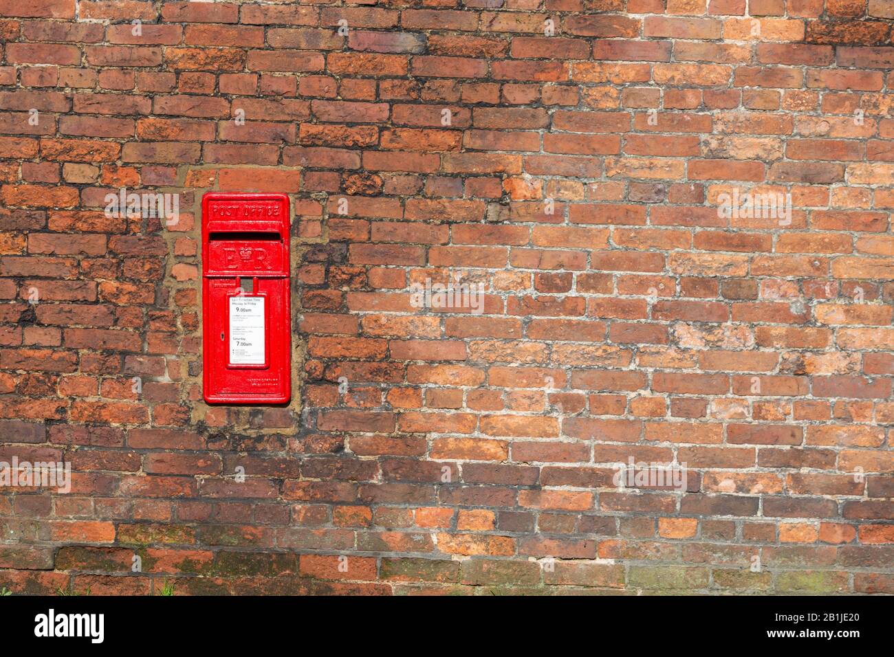Red Postbox in a wall. Ashbourne, Derbyshire, UK Stock Photo - Alamy