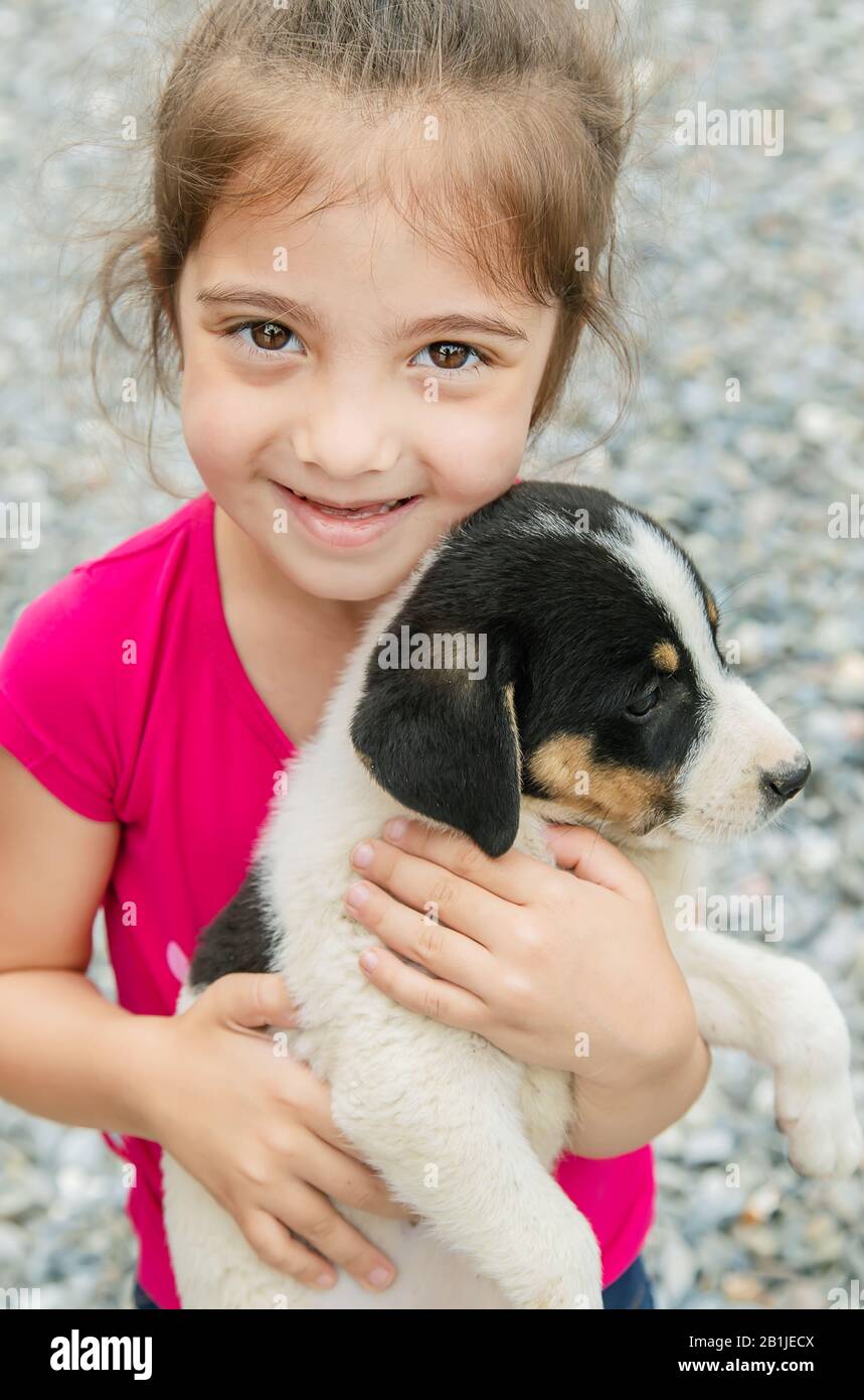 Children with a little puppy. Selective focus Stock Photo - Alamy