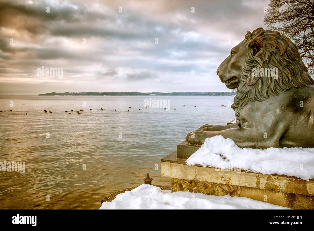 bronze lion on the Starnberg lakefront in winter, Germany, Bavaria ...