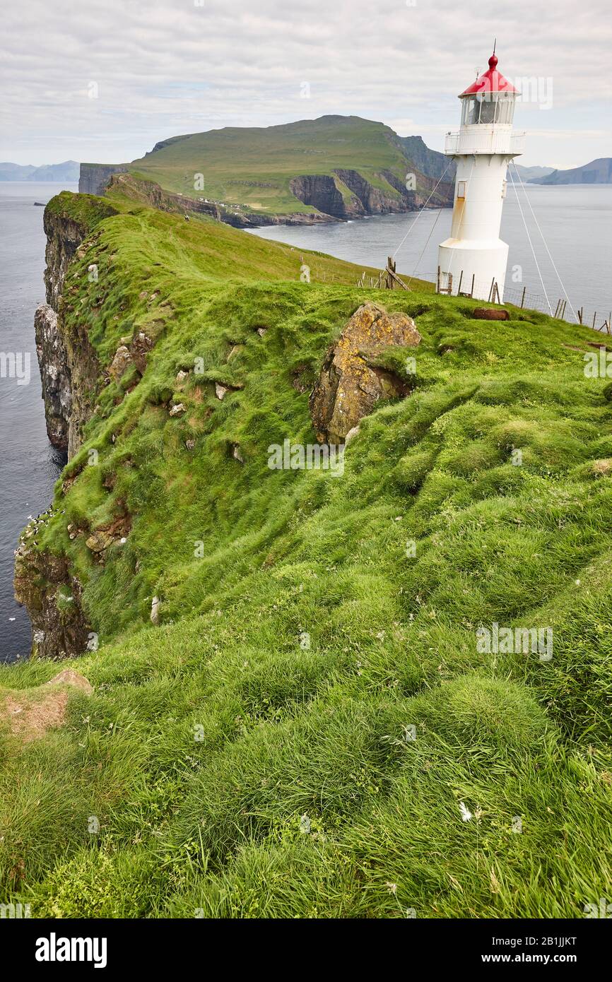 Mykines lighthouse and cliffs on Faroe islands. Hiking landmark ...