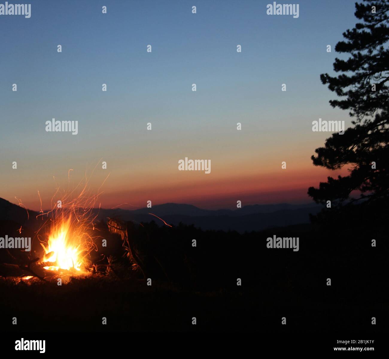 campfire at sunset Stock Photo - Alamy