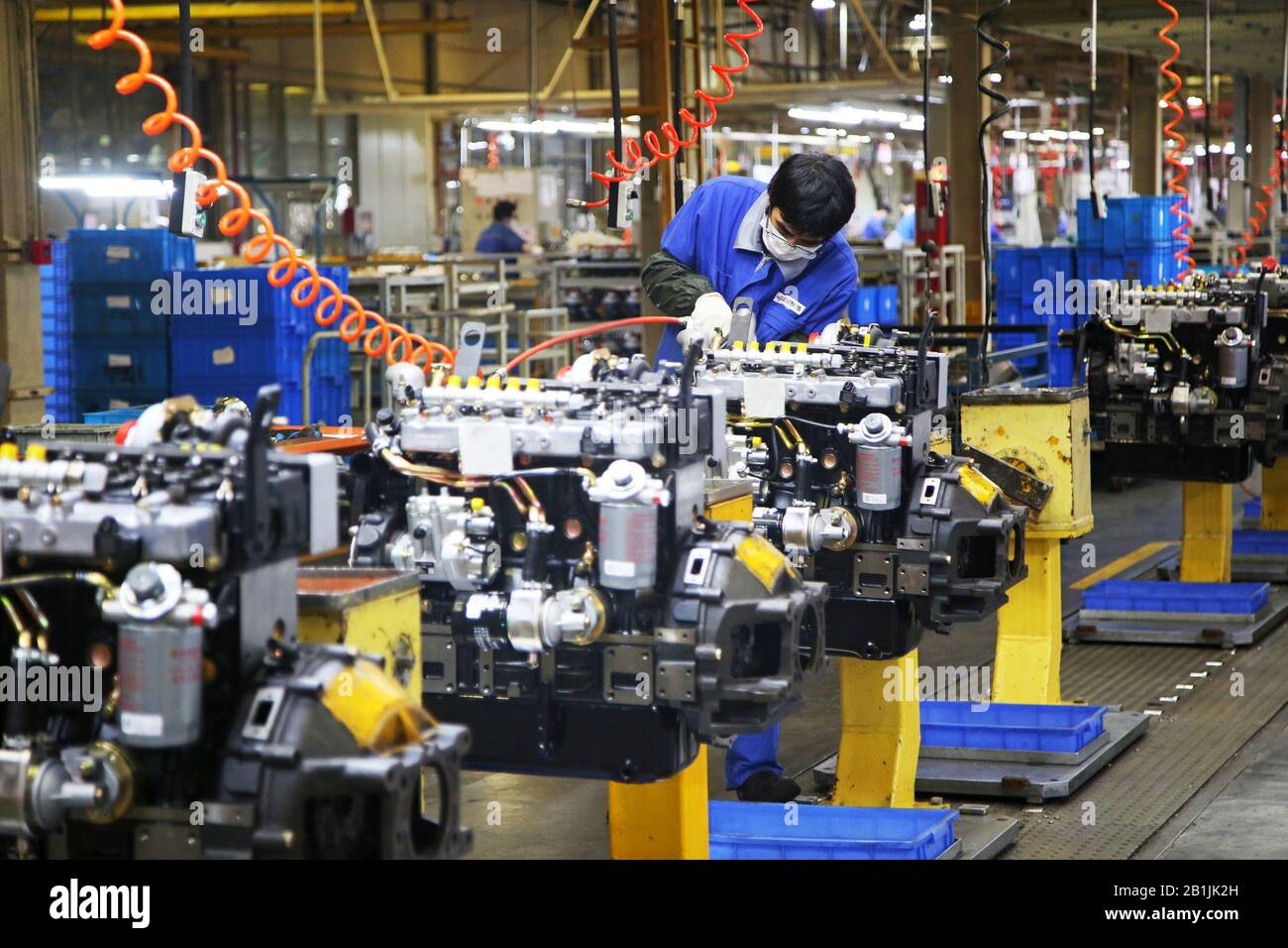 Chinese workers assemble agricultural machinery engines on the assembly ...