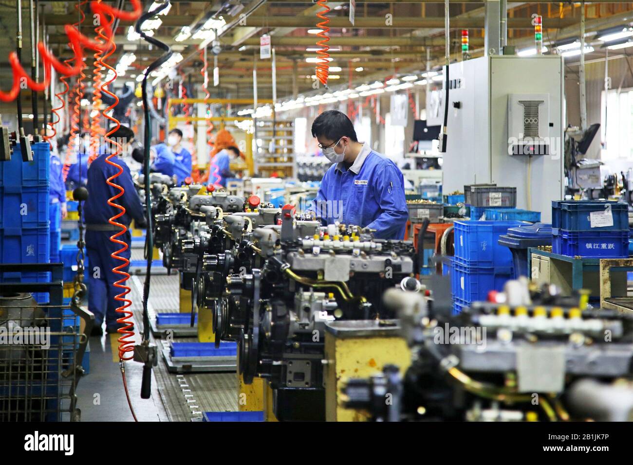 Chinese workers assemble agricultural machinery engines on the assembly ...