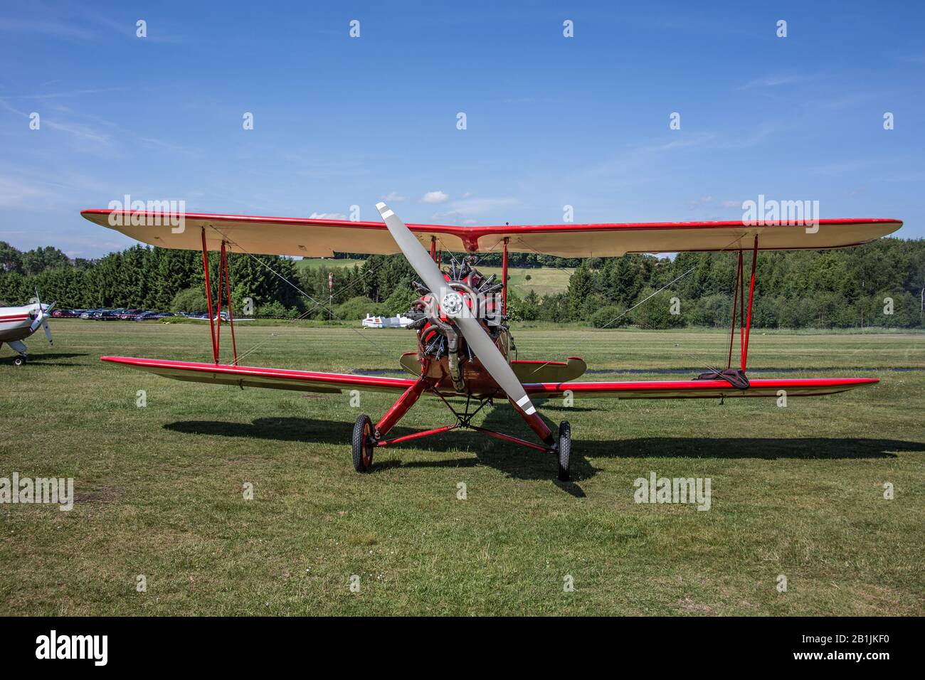 red biplane airplane on meadow Stock Photo - Alamy