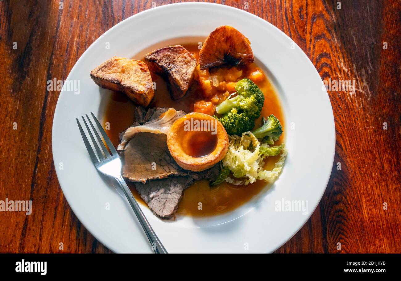 Traditional British Sunday lunch with roast beef and Yorkshire pudding ...