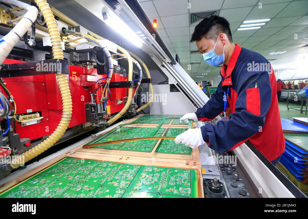 Chinese workers manufacture printed circuit boards (PCB) which are used ...