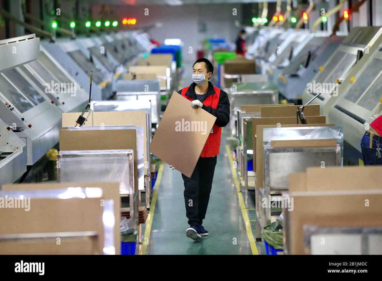 Chinese workers manufacture printed circuit boards (PCB) which are used ...