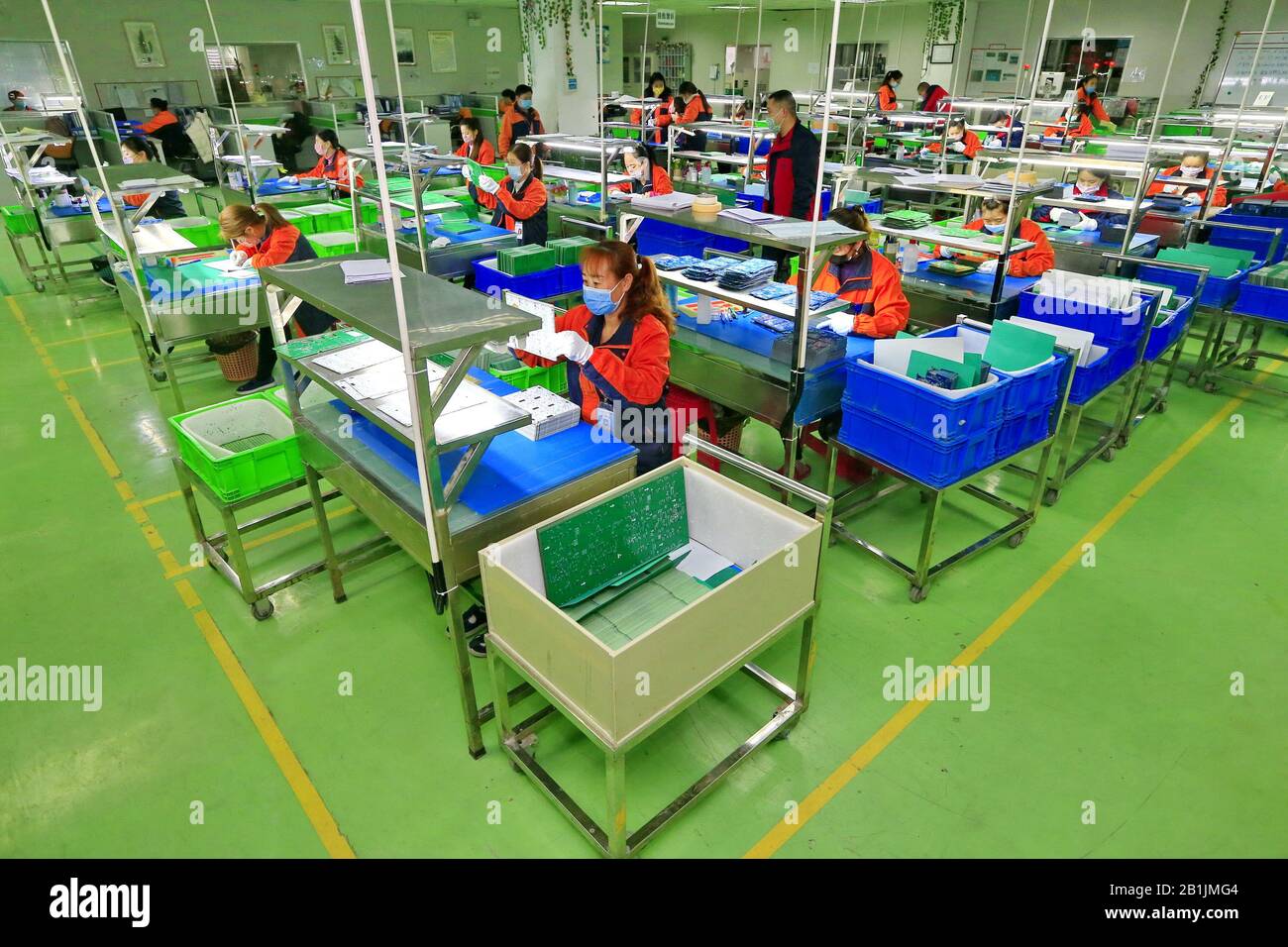 Chinese workers manufacture printed circuit boards (PCB) which are used ...