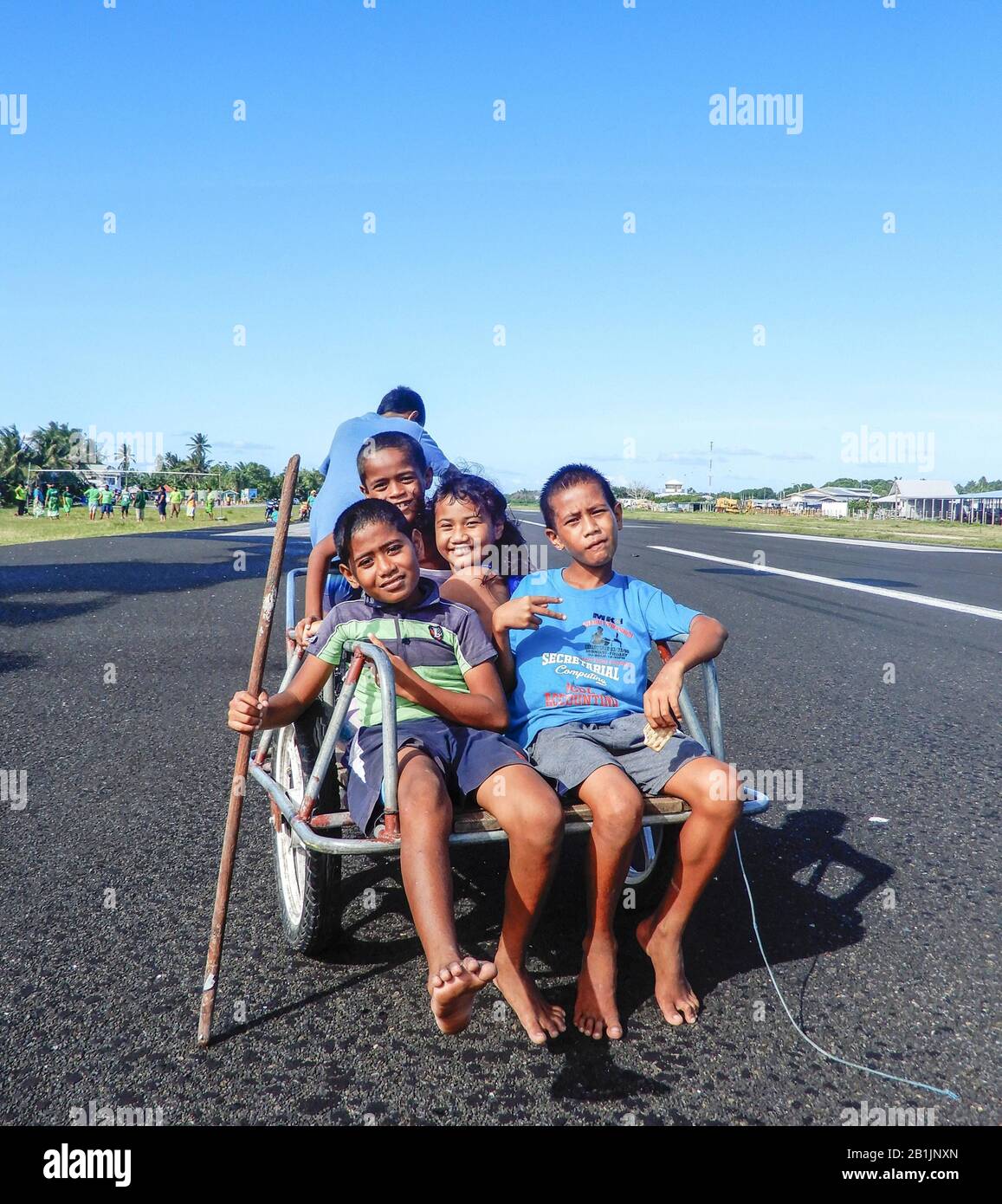 Children play on an airport runway in the Tuvaluan capital of Funafuti ...