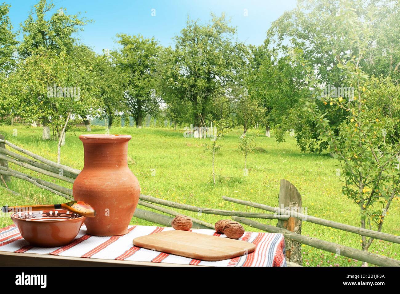 ukrainian cozy summer landscape with national food on table and garden ...