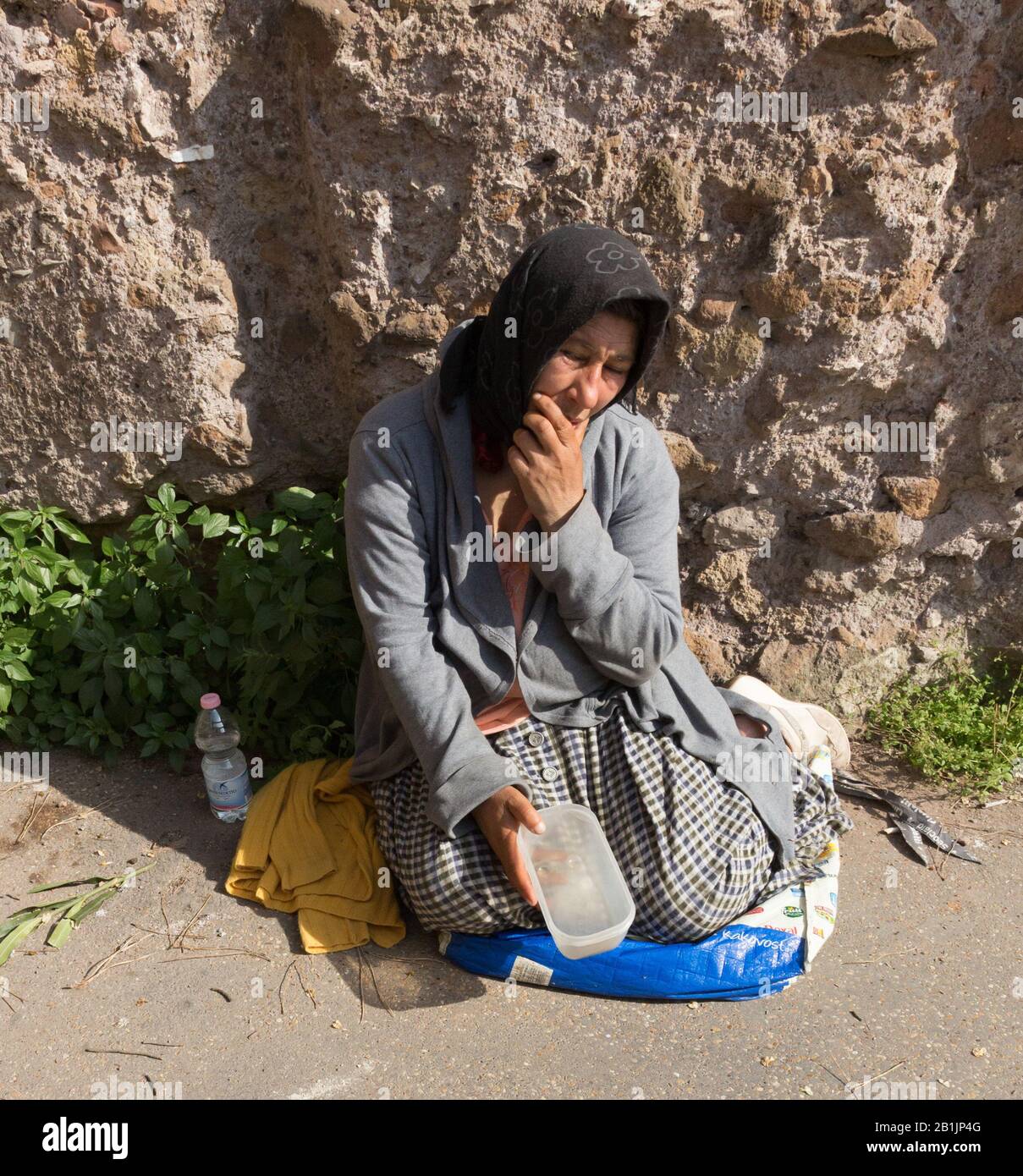 Woman begging in the street hi-res stock photography and images - Alamy