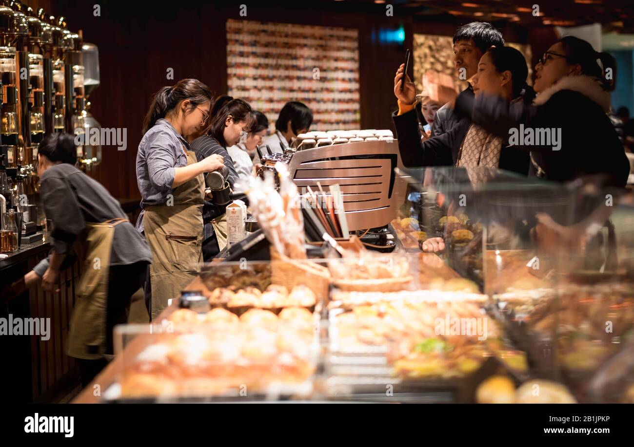 SHANGHAI, CHINA - JANUARY 11, 2020: A Starbucks barista making coffee ...