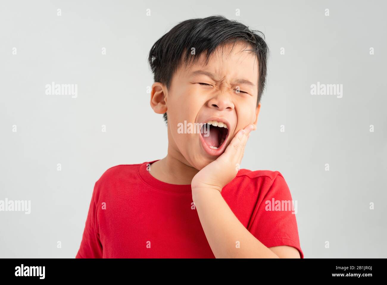 Little boy having toothache. Emotional portrait of asian boy suffering ...