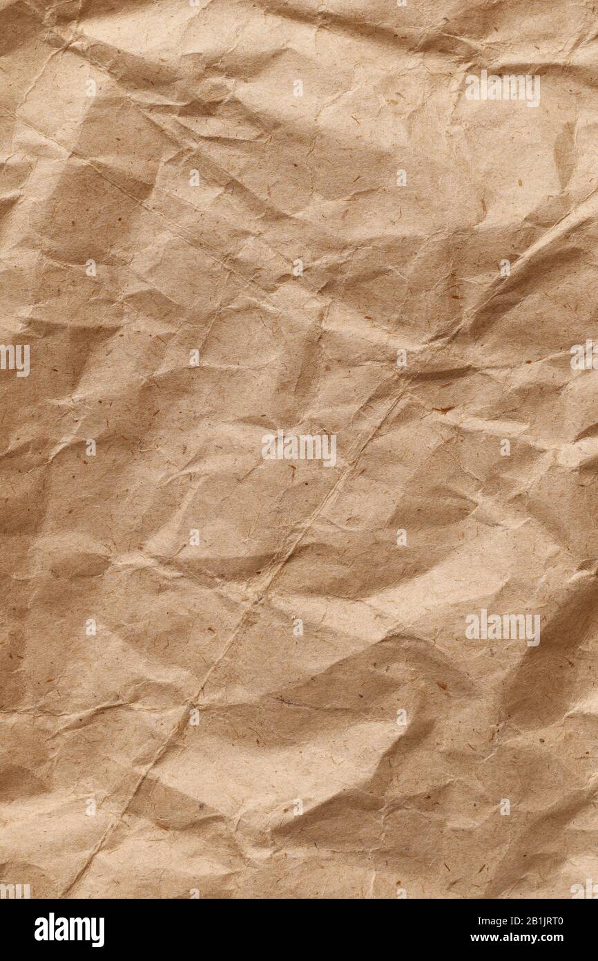 A vertically oriented piece of crumpled used wrapping paper with rough ...