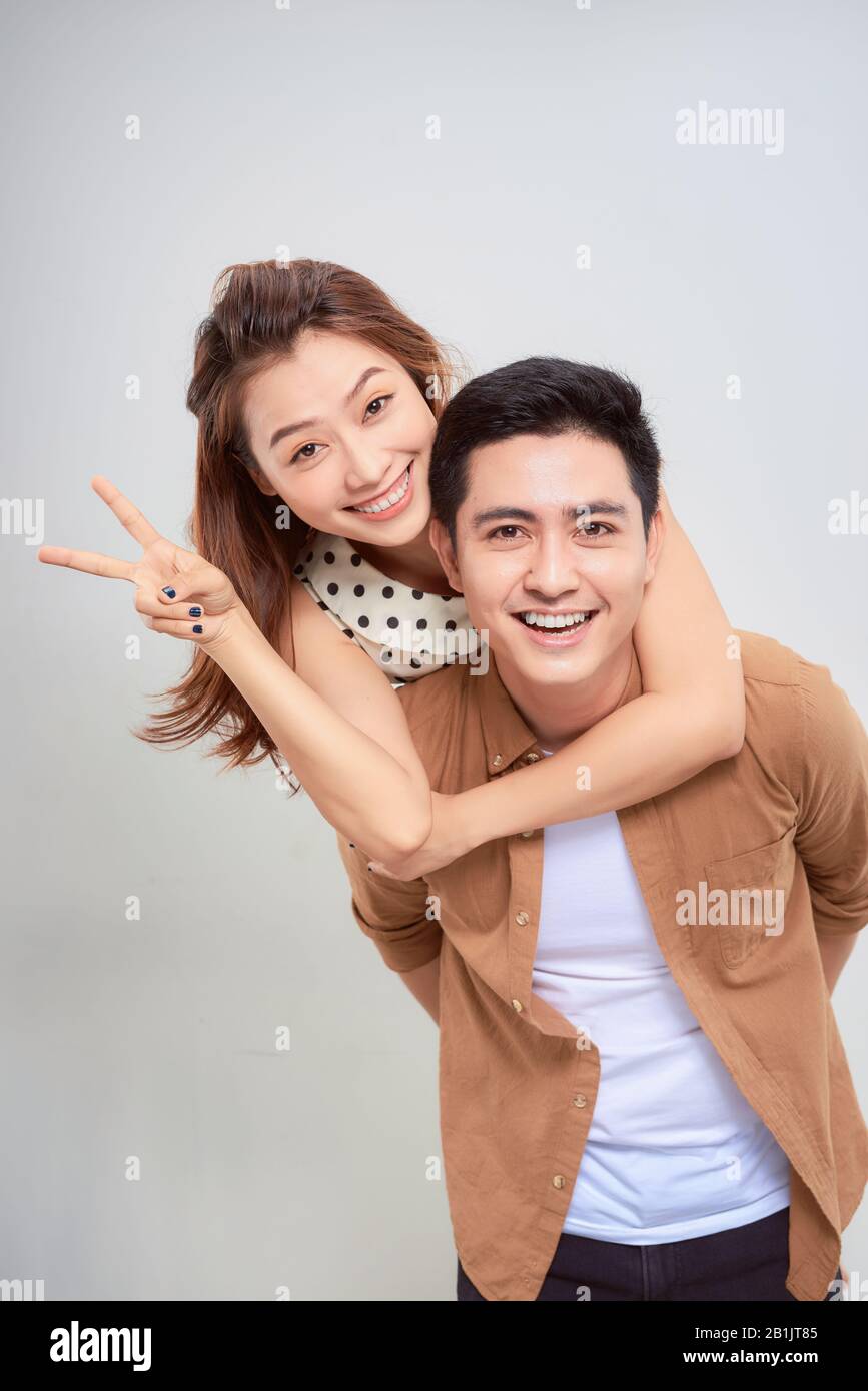 Portrait of lovely guy carrying his passion making v-signs isolated ...