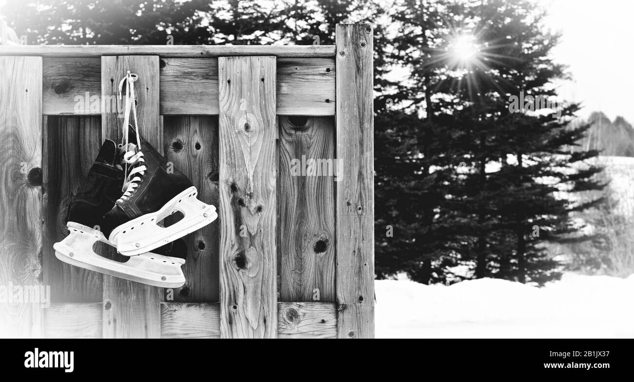 Hockey skates hanging on outdoor wooden planks Stock Photo - Alamy
