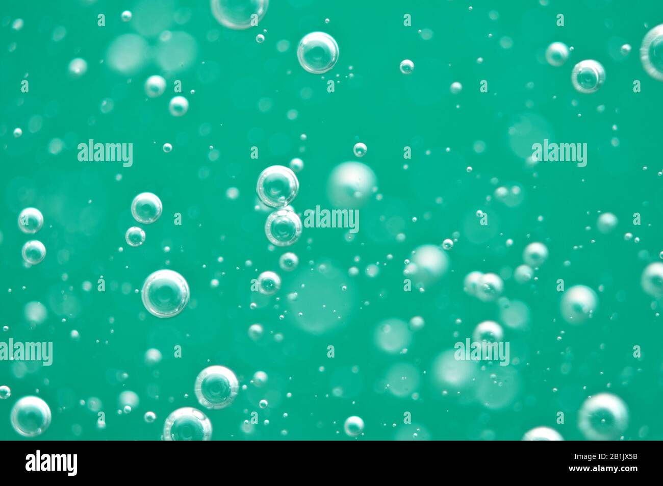 Beautiful turquoise background. Rising air bubbles in clear water ...