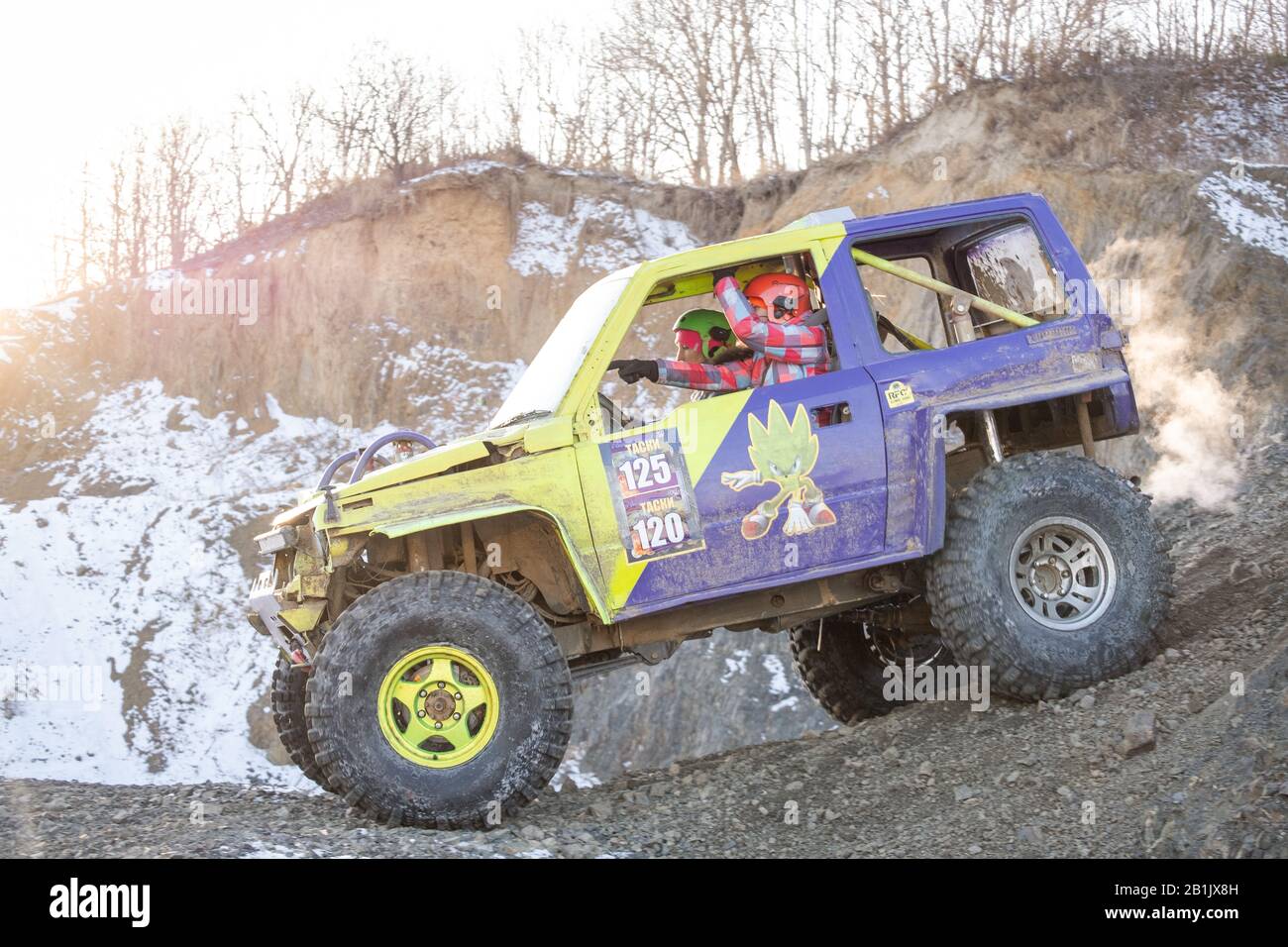 Jeep Suzuki Jimny overcomes obstacles in the forest Stock Photo - Alamy