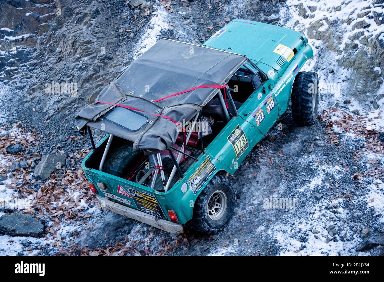 Jeep Suzuki Jimny overcomes obstacles in the forest Stock Photo - Alamy