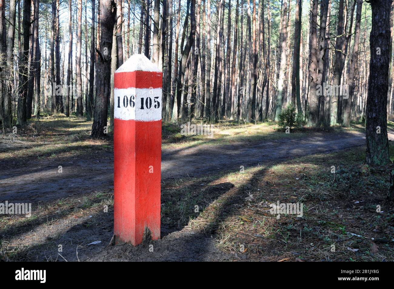 The wooden quarter post is red and white. Marking post indicating the ...