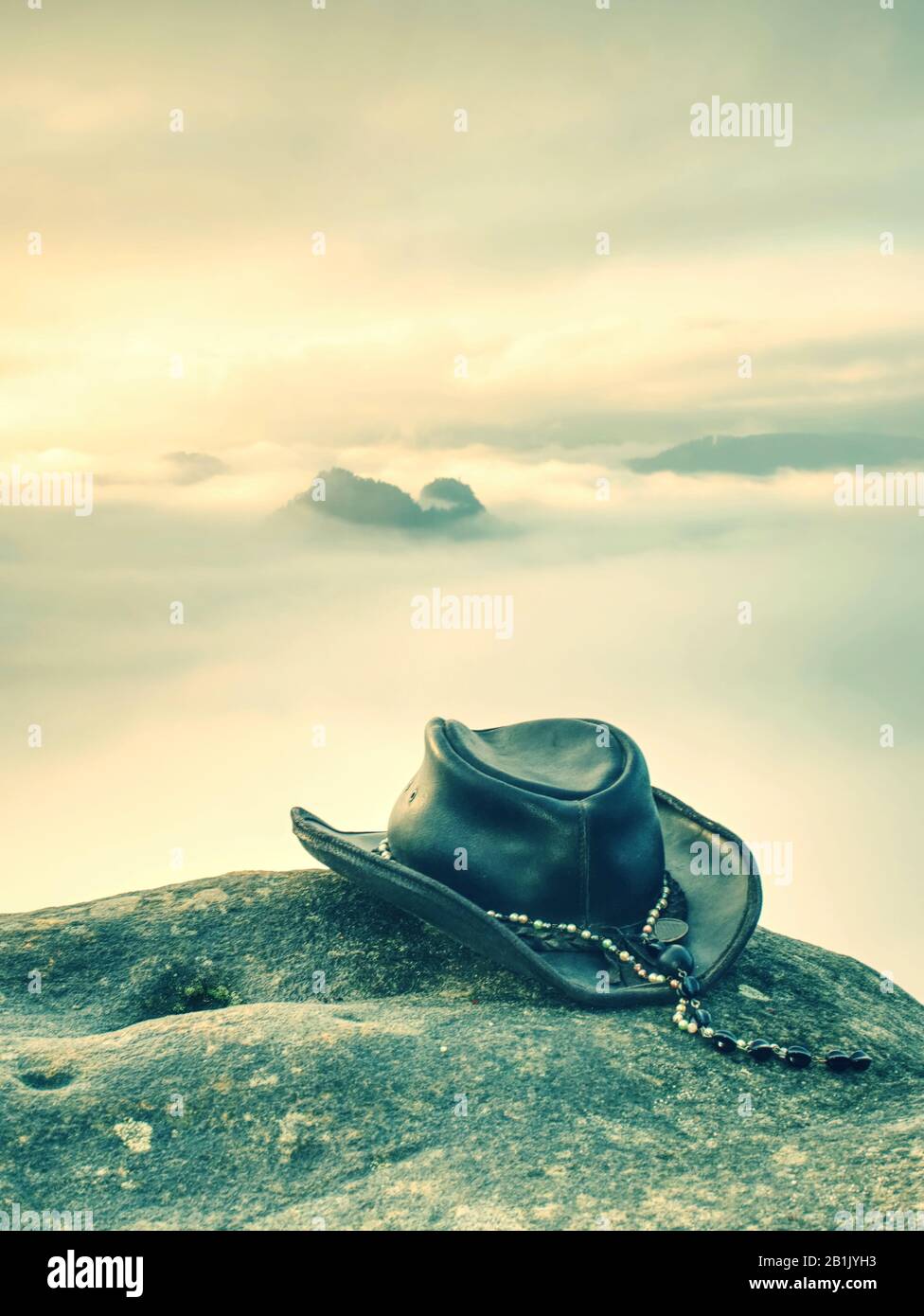 Cowboy hat ready on the rock. Leather cowboy accessories Stock Photo ...