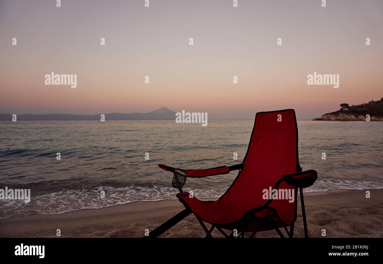 Camping chair at seaside at sunset Stock Photo - Alamy