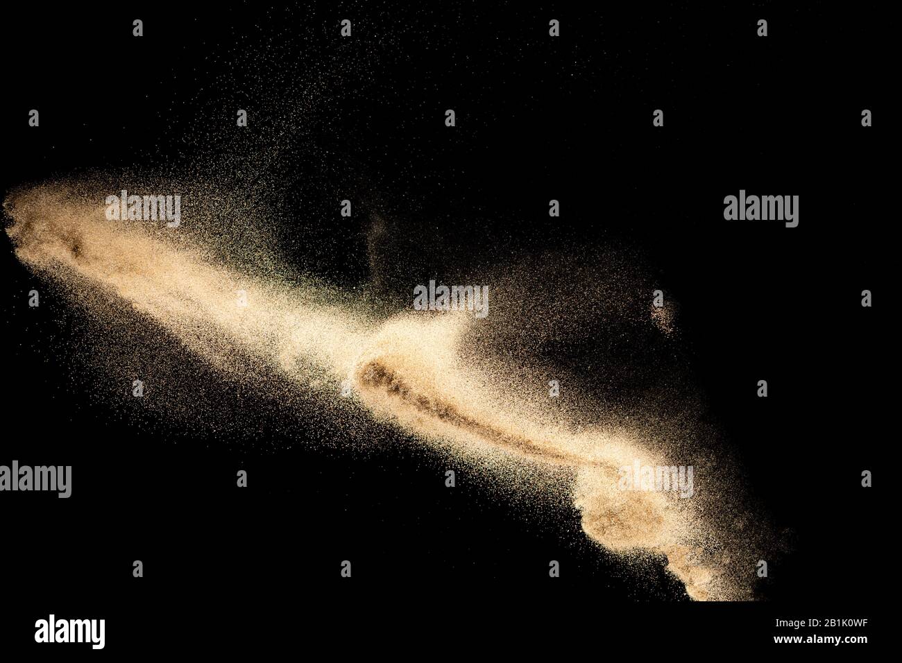 Brown colored sand splash.Dry river sand explosion isolated on black ...