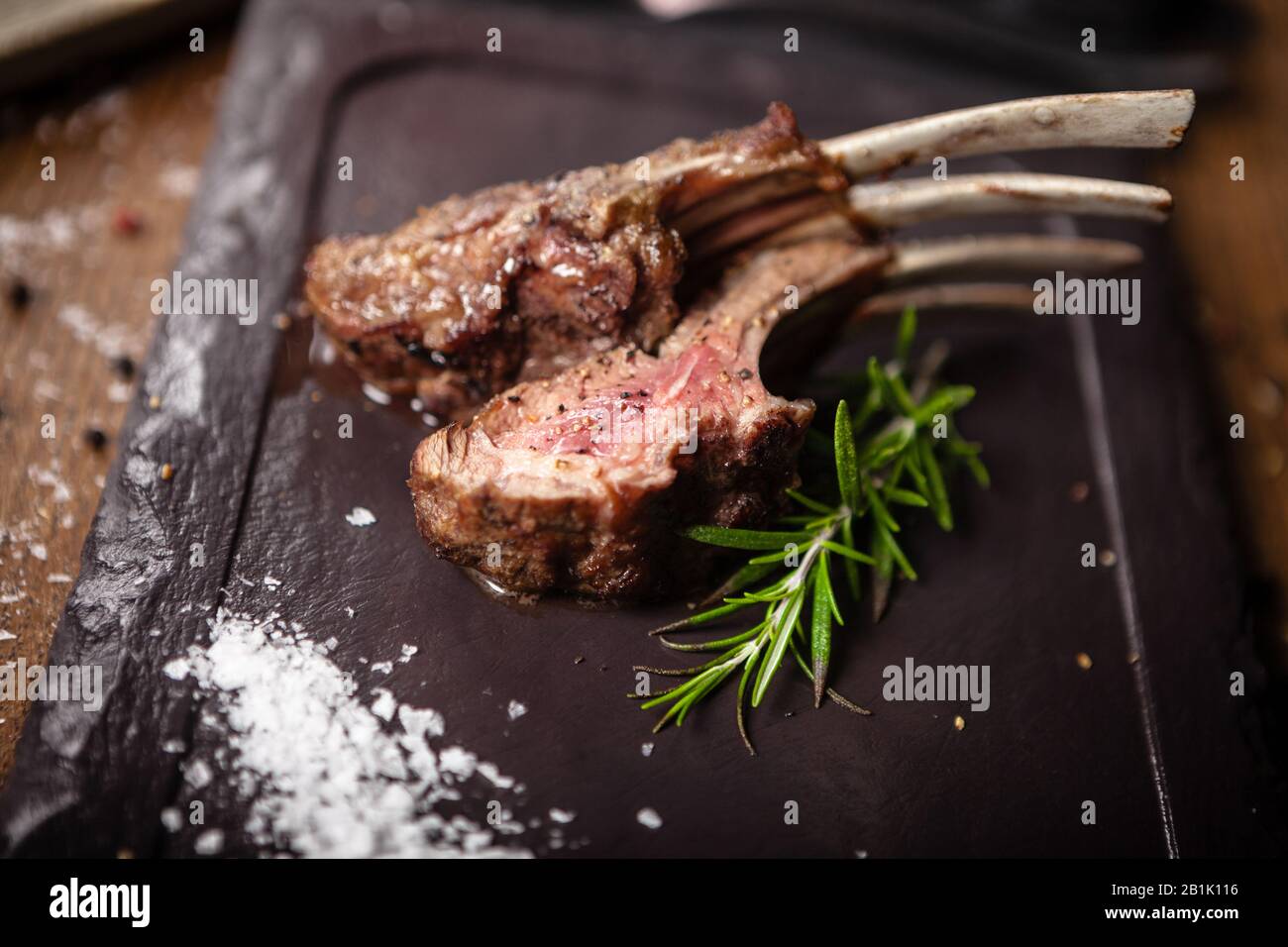 Grilled lamb chops served with a branch of rosemary Stock Photo - Alamy