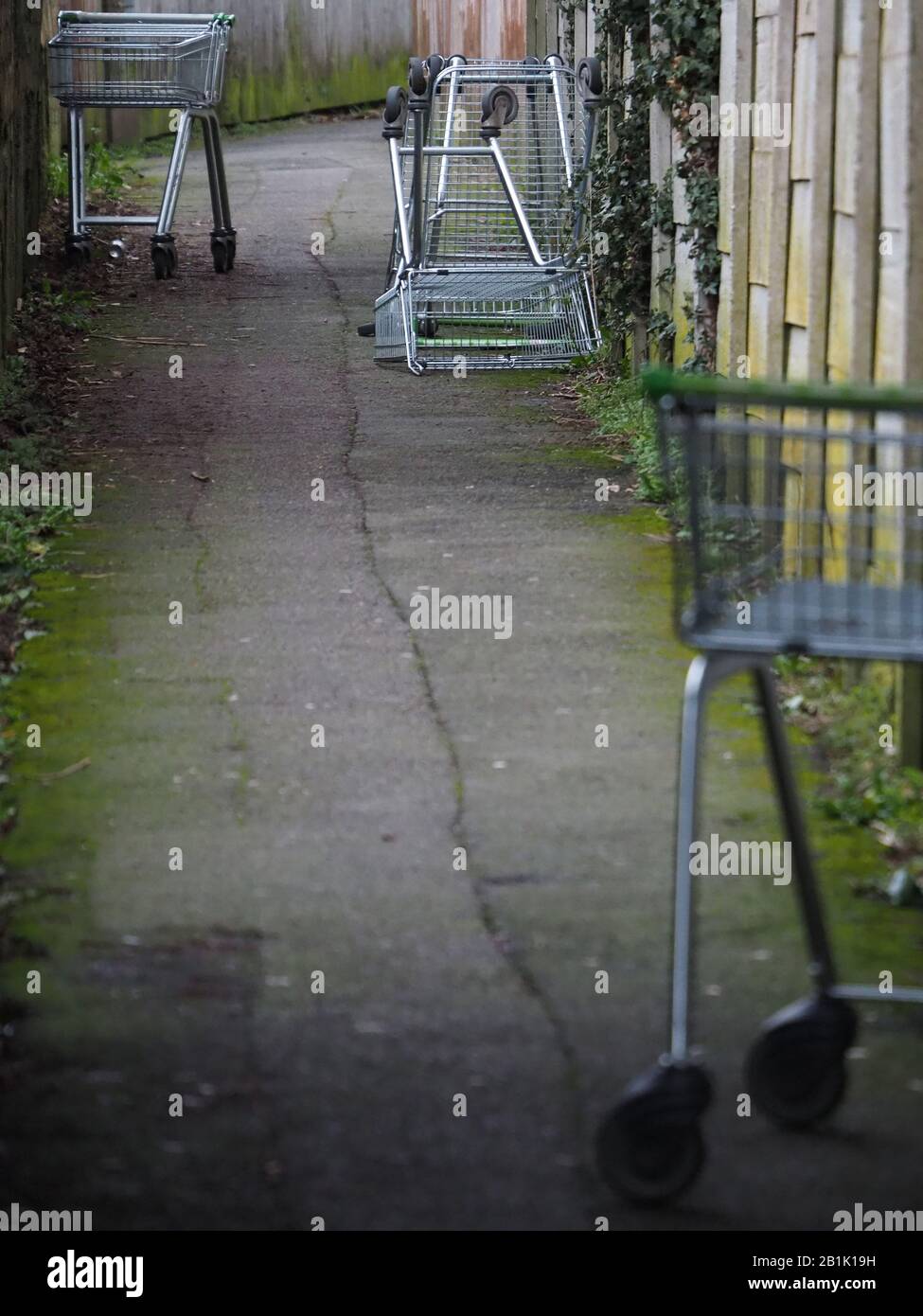 Shopping trolleys dumped in alleyway / walkway Stock Photo - Alamy