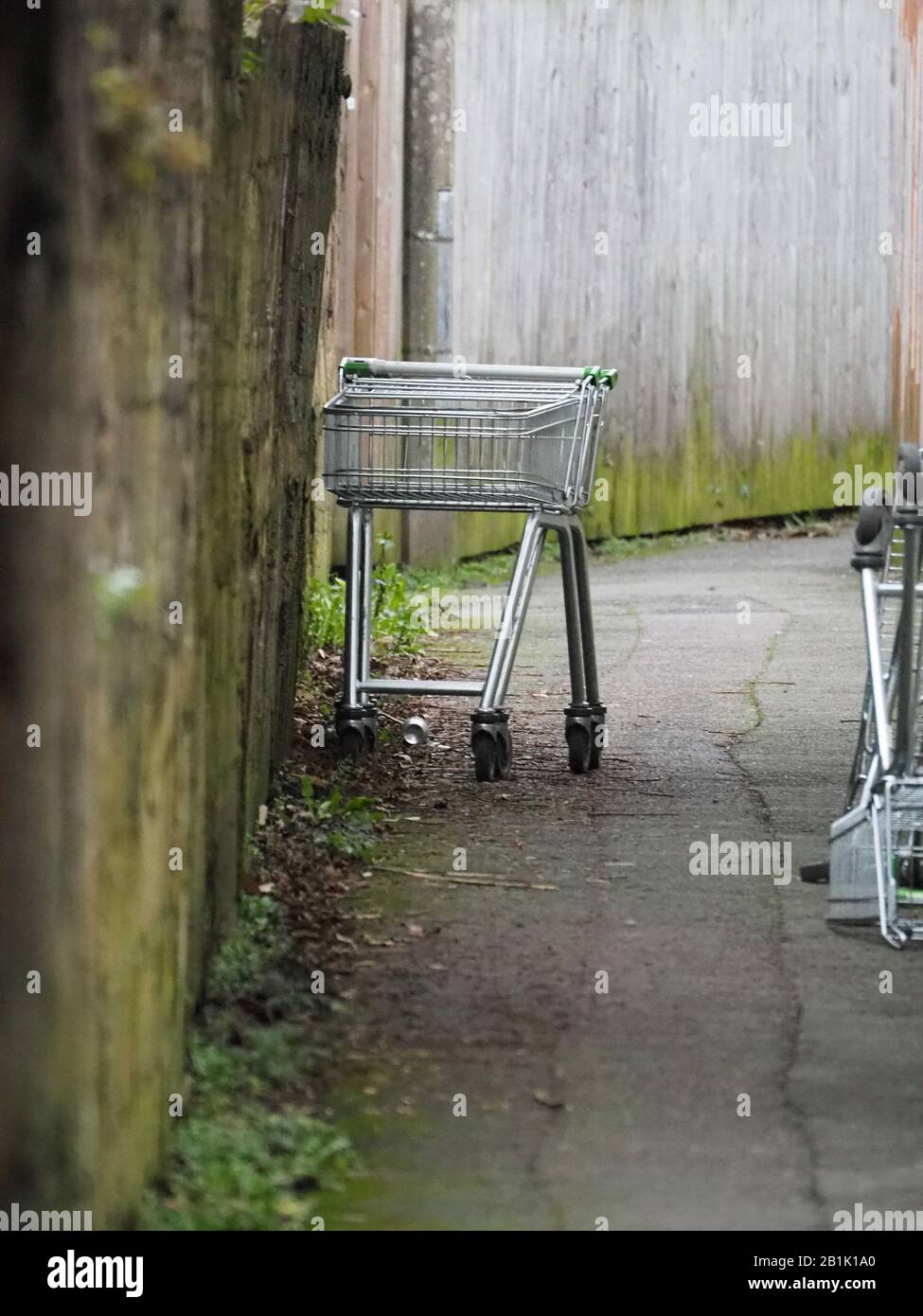 Shopping trolleys dumped in alleyway / walkway Stock Photo - Alamy