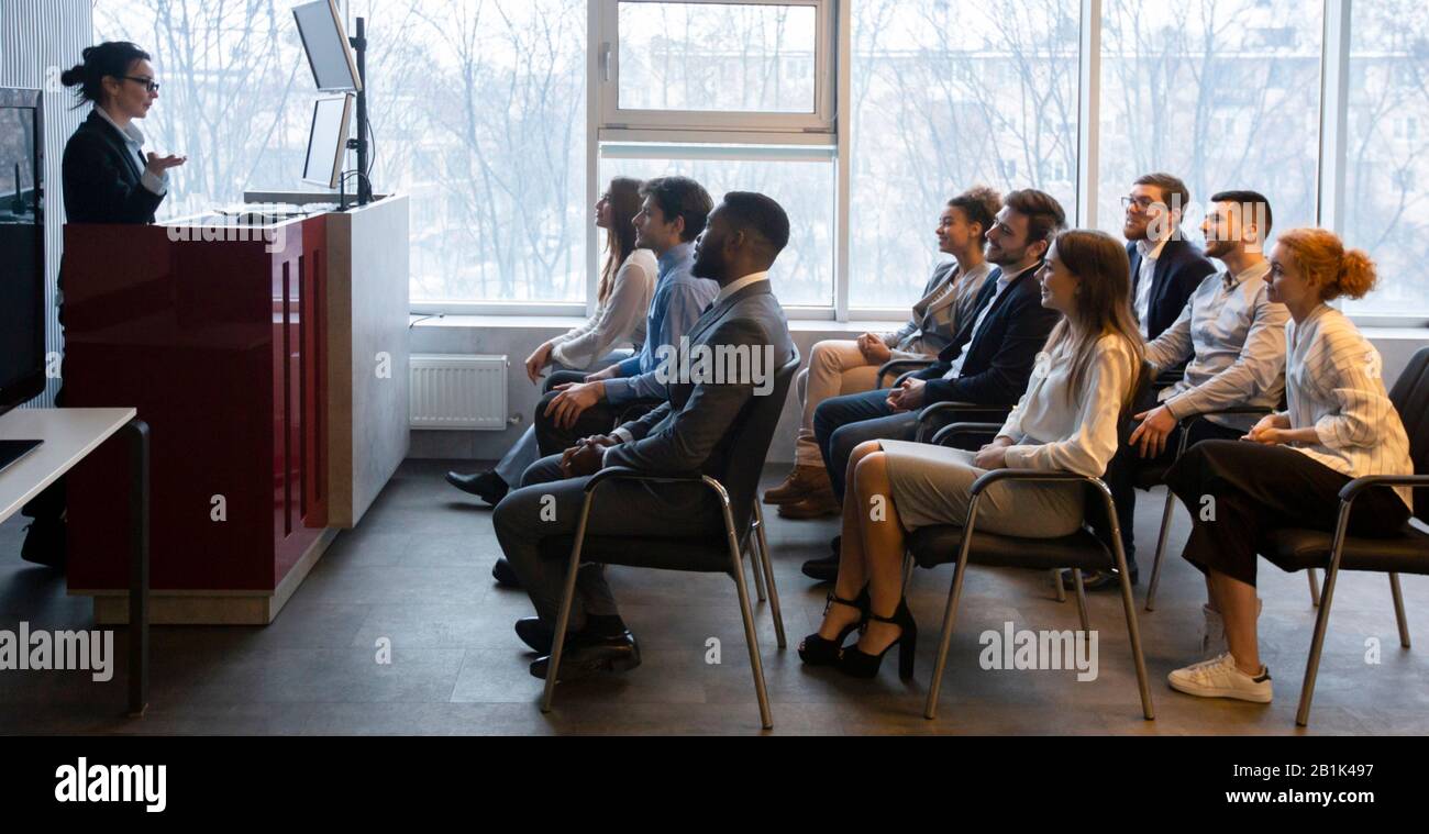 Business training. Boss giving presentation to young staff Stock Photo ...