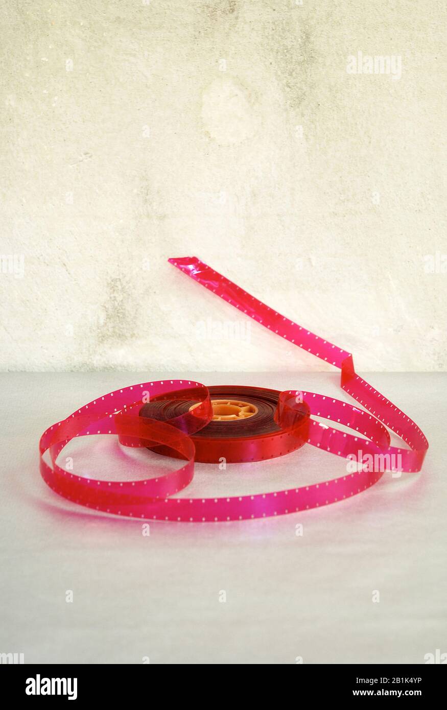 Celluloid vintage film strip red negativ vertical on grunge background ...