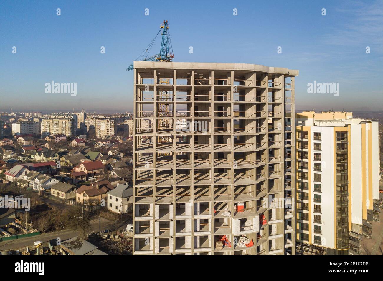 Aerial view of concrete frame of tall apartment building under ...