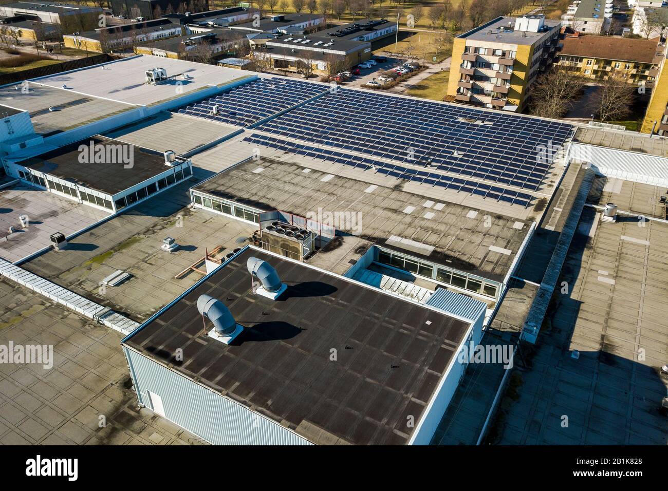 Aerial view of many photo voltaic solar panels mounted of industrial ...