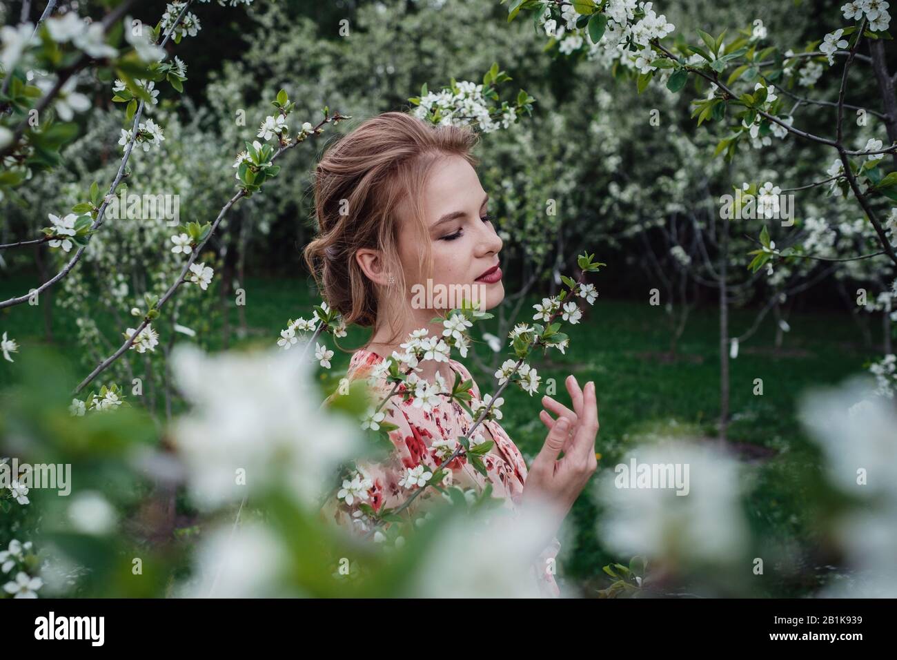 Lady smells flowers hi-res stock photography and images - Alamy