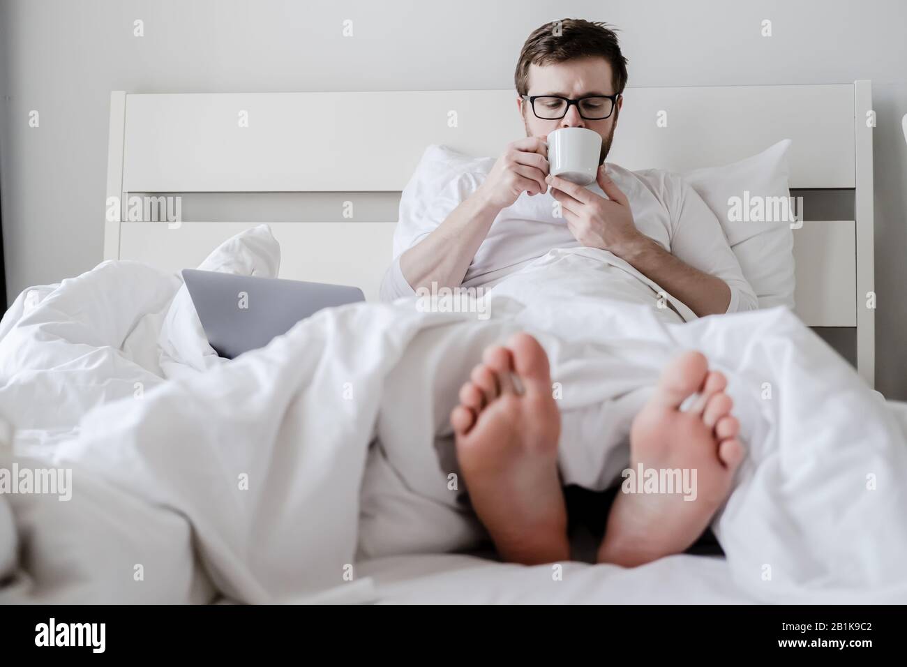 Feet in bed under covers hi-res stock photography and images - Alamy