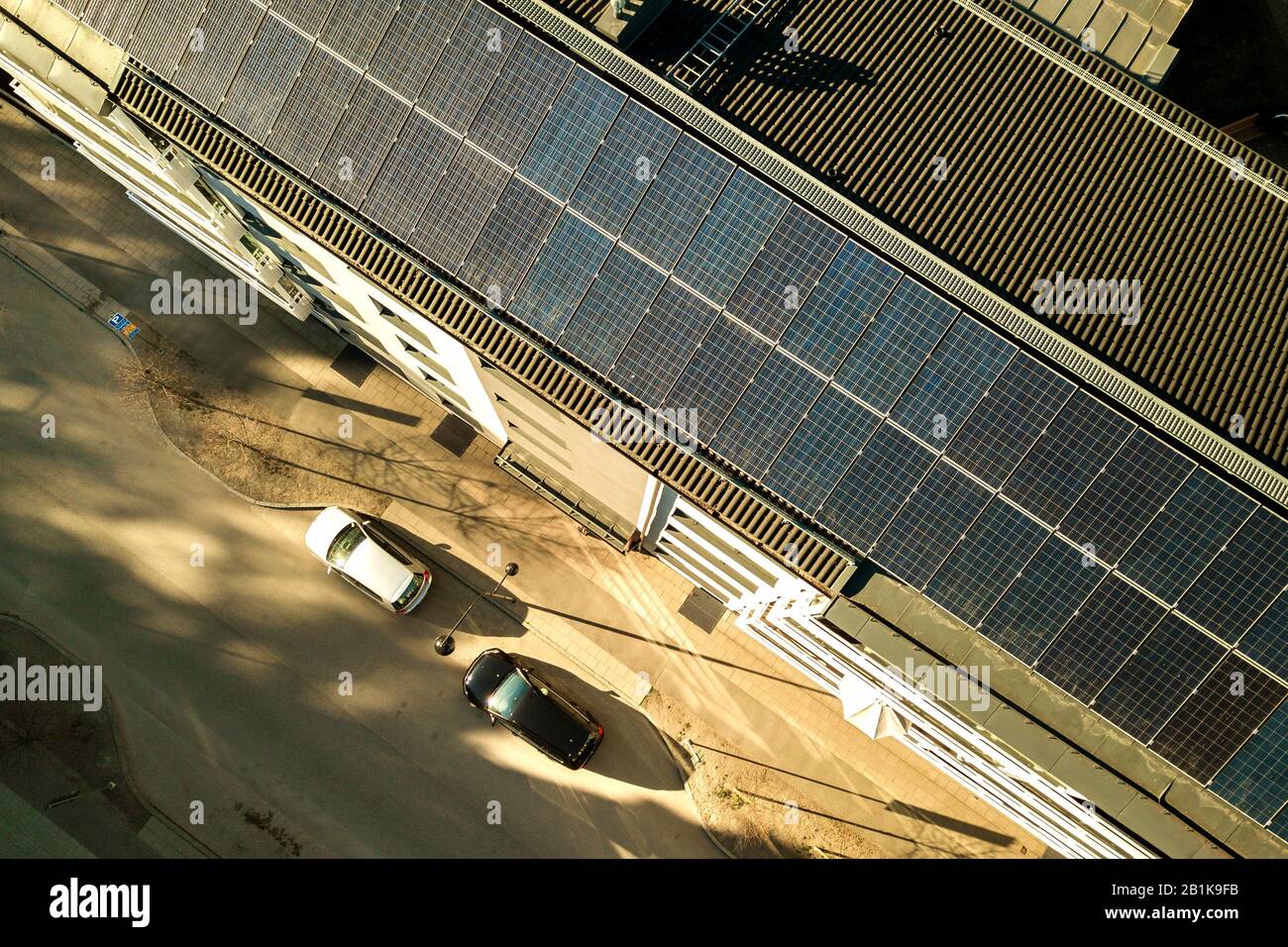 Aerial view of solar photovoltaic panels on a roof top of residential ...
