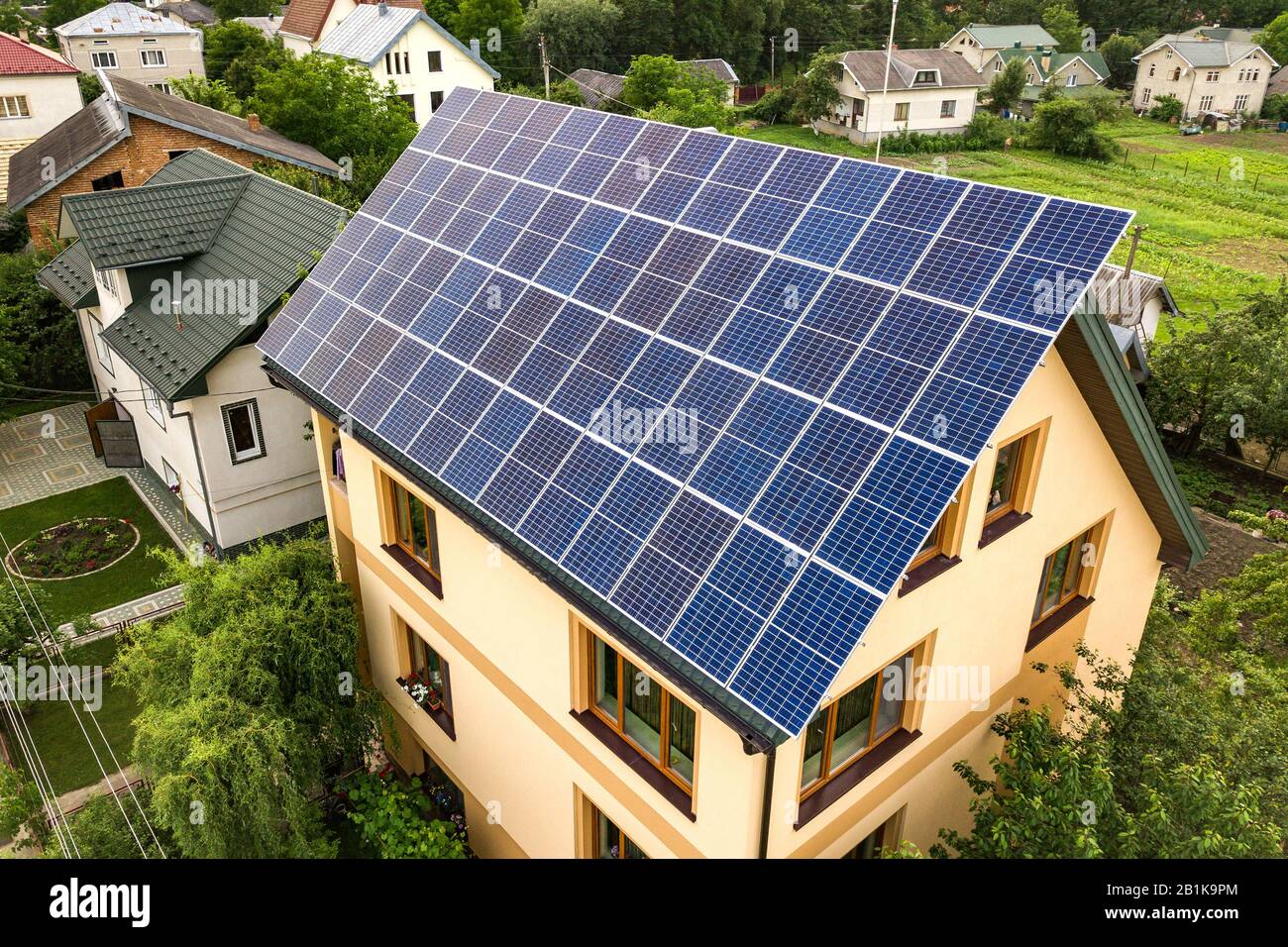 Aerial top view of new modern residential house cottage with blue shiny ...
