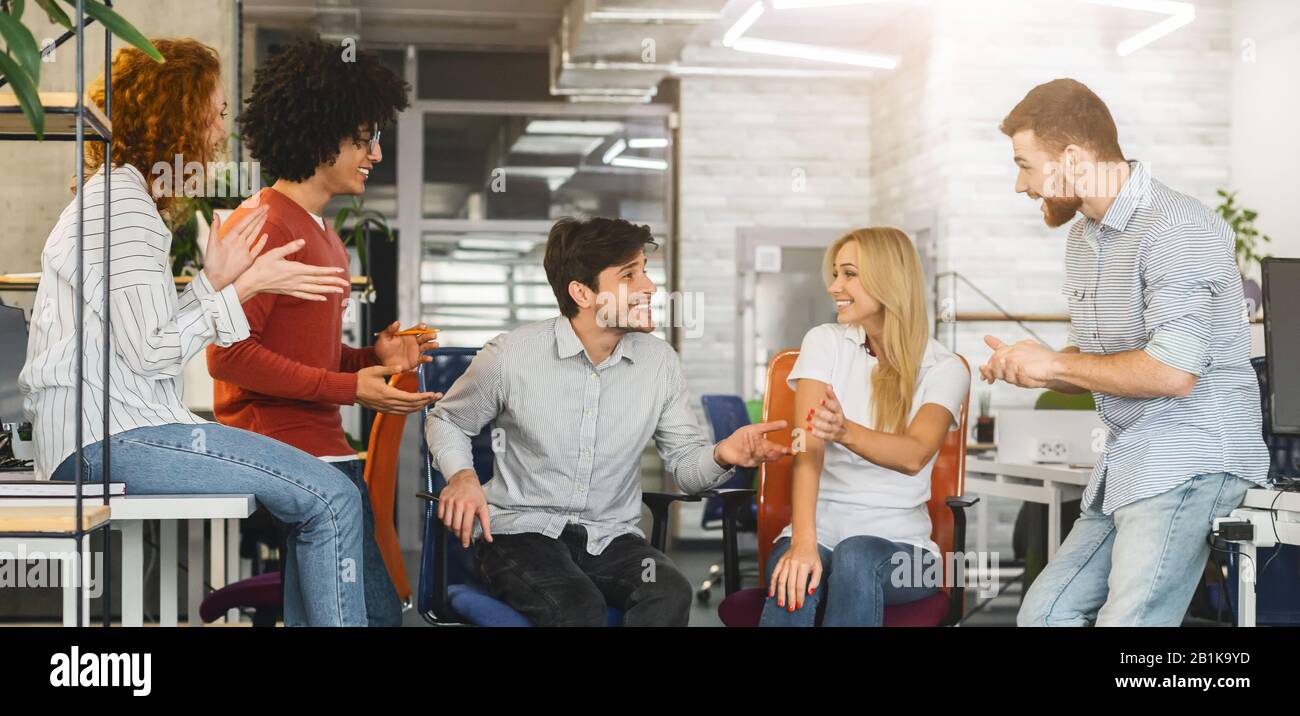 Joyful young colleagues talking and joking during meeting Stock Photo ...