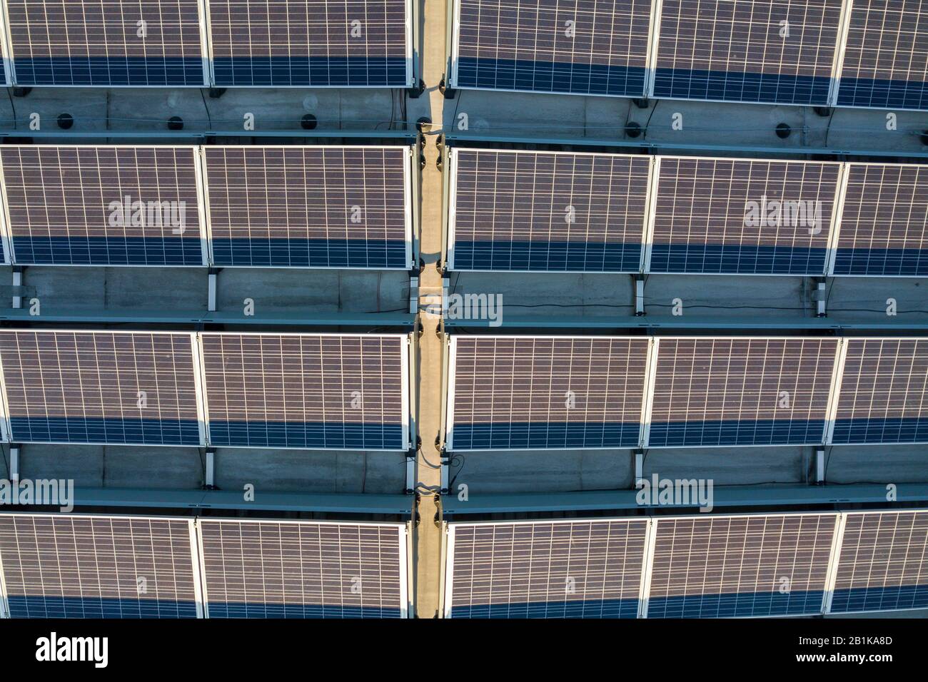 Aerial view of many photo voltaic solar panels mounted of industrial ...