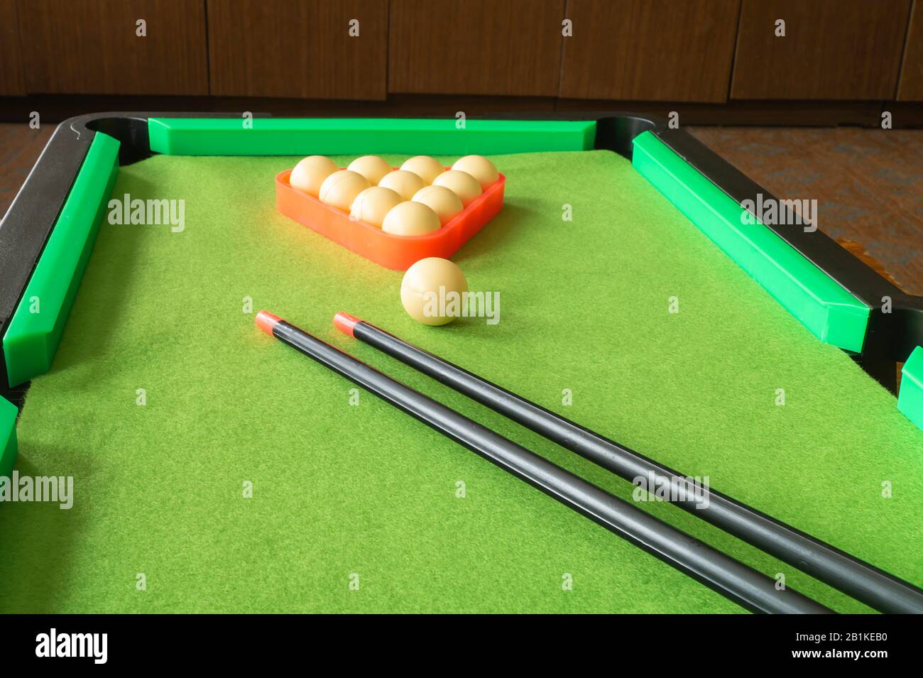The Cue with ball on green table for game of billiards. Atheletic and ...