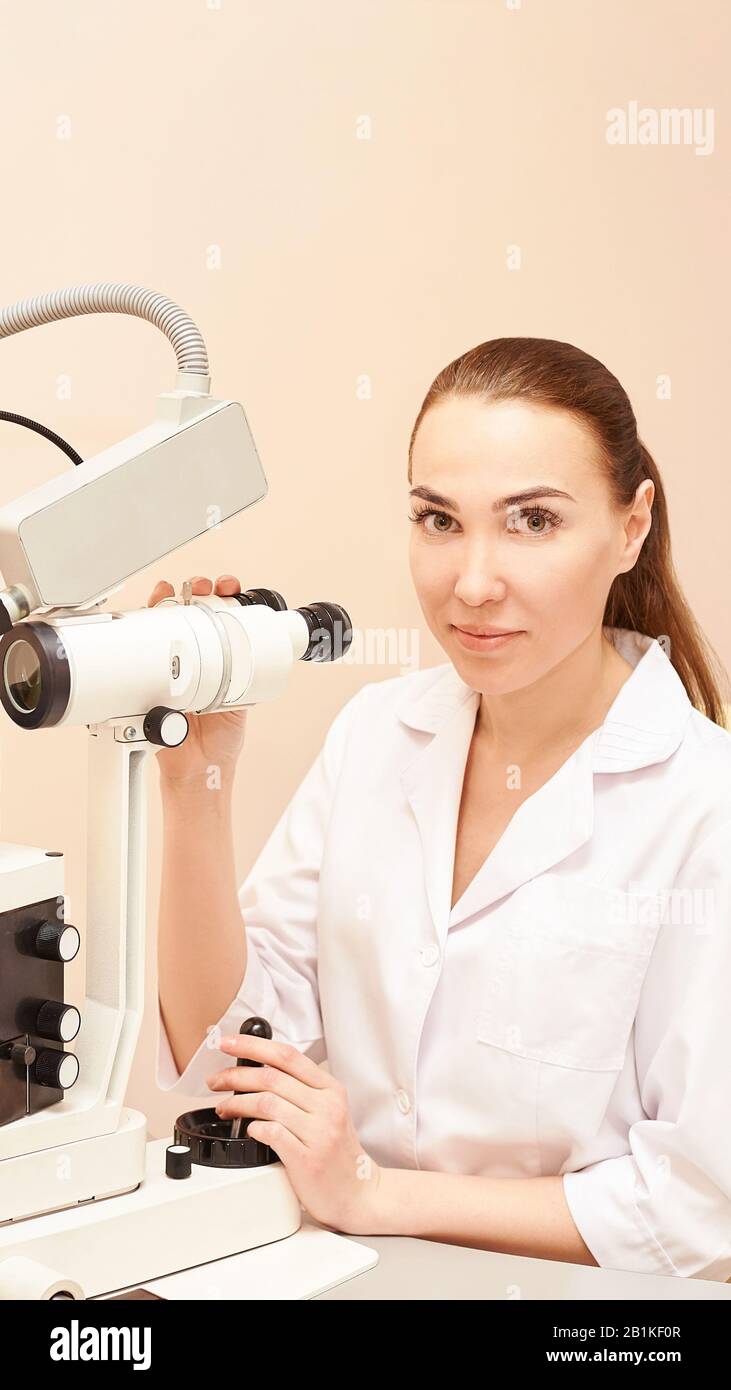 ophthalmologist doctor in exam optician laboratory with female patient ...
