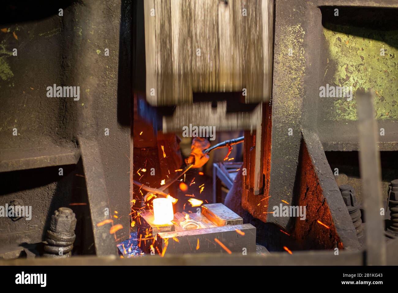 close-up picture of hot steel forging process with big mechanical ...